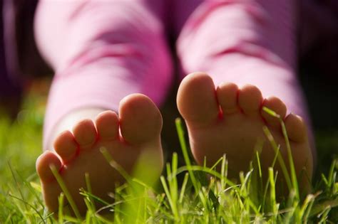 Premium Photo Girls Feet In Grass