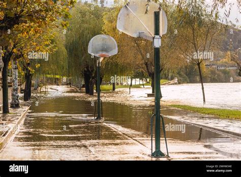 Road Sign And Sidewalk Flooded Due To River Overflow Due To Constant