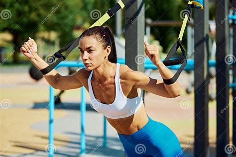 Woman Executes Trx Exercise Her Body Leaning Forward Arms Extended Athlete Fully Engaged In