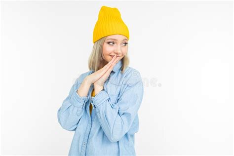 Close Up Of An Embarrassed Cute Girl In A Blue Denim Jacket On A White