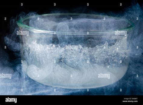 Liquid Nitrogen Vigorously Boiling In Clear Glass Bowl At Room Stock