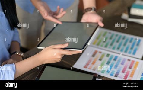 Close Up View Of Young Designer Team Consulting On Their Project With