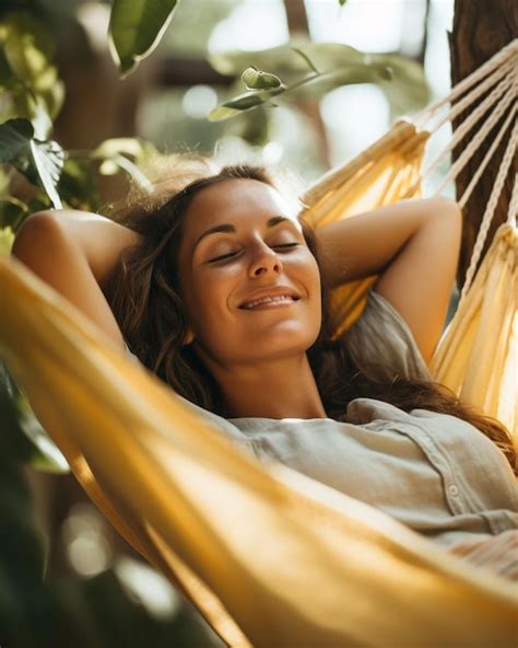 Premium Photo A Relaxed Woman Rests Lying In A Hammock