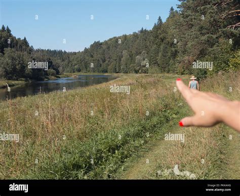 Man Walking Away And Female Hand Pointing Him Direction Outdoor