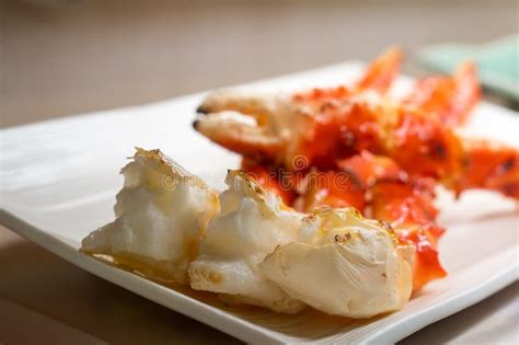 King Crab Legs Grilled Served On A White Plate Showcasing The Tender