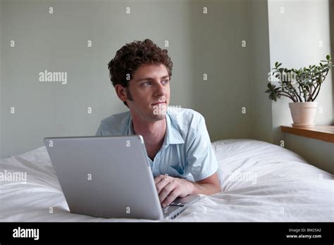 Man On The Bed With A Laptop Stock Photo Alamy