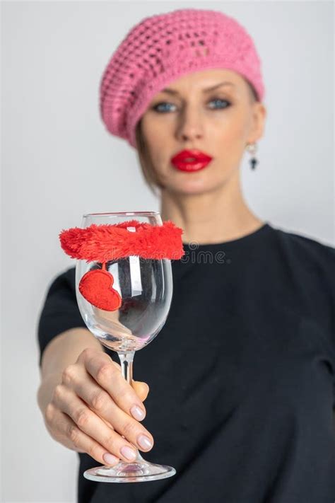 Beautiful Romantic Girl In Pink Beret Holds Glass With Decorative Red Heart Selective Focus