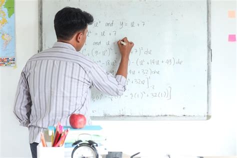 Premium Photo Rear View Of Teacher Writing Mathematics Problem On