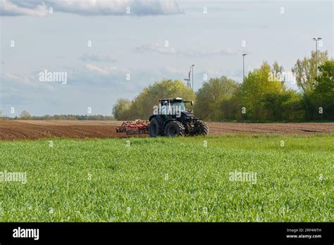 In The Foreground Is A Field With Green Grass On The Field The