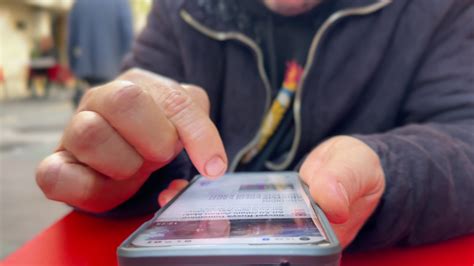Man Surfing Internet By Swiping His Mobile Phone Screen With His Finger
