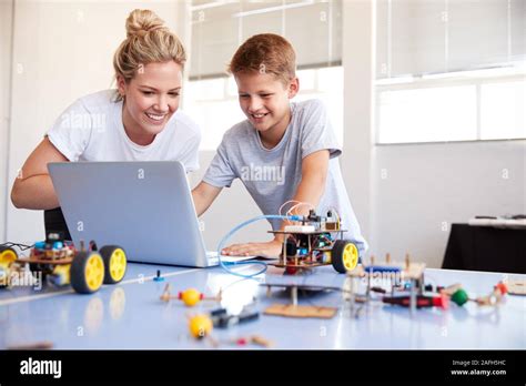 Male Babe With Teacher Building Robot Vehicle In After Babe Computer Coding Class Stock