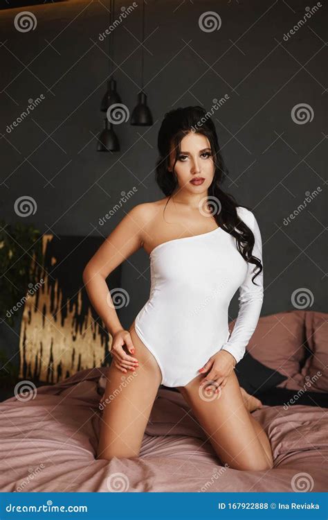 Beautiful Young Woman In An Elegant White Bodysuits Portrait Of