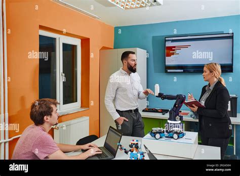 A Group Of Colleagues Working Together In A Robotics Laboratory