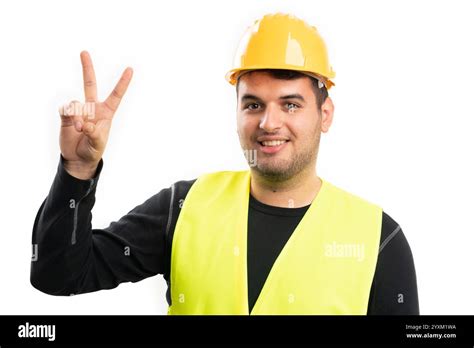 Cheerful Male Constructor Wearing Work Attire Hardhat And Vest Making
