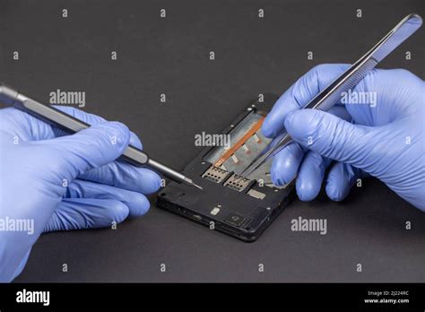 Process Of Mobile Phone Repair Hands Of A Service Worker Repairing Modern Mobile Phone Stock