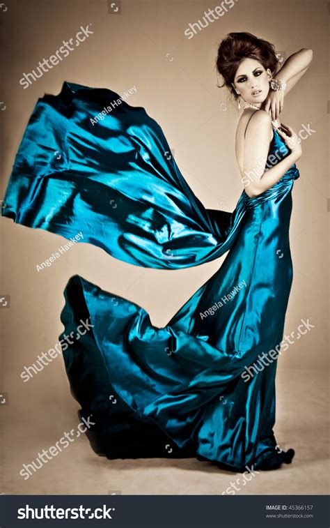 Beautiful Young Woman Holding A Blue Silk Dress In A Fashion Portrait