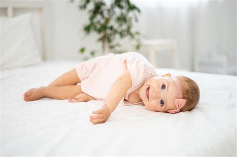 Premium Photo A Cute Little Healthy Girl Up To A Year Old In A Pink