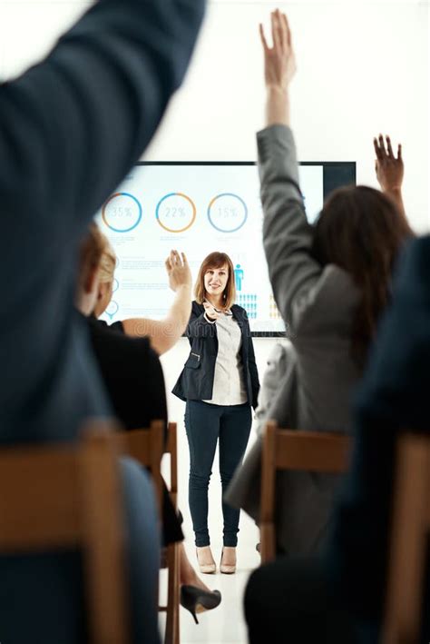 Ask Away A Young Businesswoman Answering Questions During A Presentation In The Office Stock