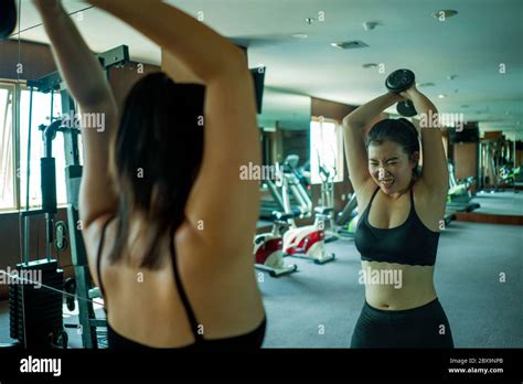 Mirror Portrait Of Young Pretty And Fit Asian Korean Woman Working Hard
