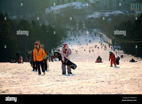Russia, Far East, Sakhalin; Yuzhno-Sakhalinsk; Two young men going up a ...