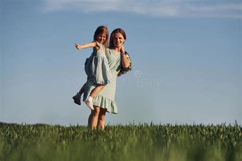 Moment Of Tenderness Mother And Daughter Have Fun Outdoors On The