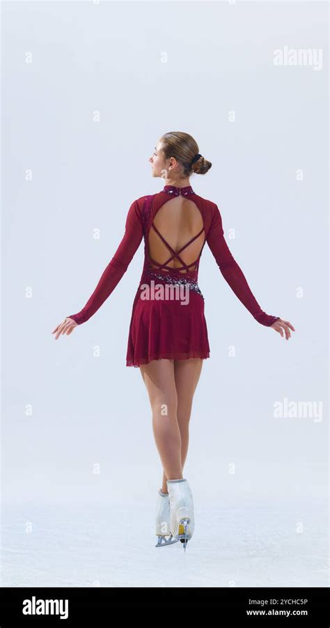 Female Figure Skater Gliding Gracefully Backward On Ice Her Arms