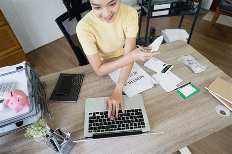 Young Woman Managing Finances at Home, Paying Bills Online with Laptop and Calculator, Budgeting ...
