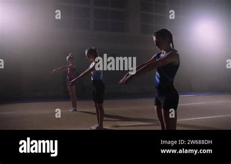 Training Of Young Female Gymnasts Three Sporty Teen Girls Are