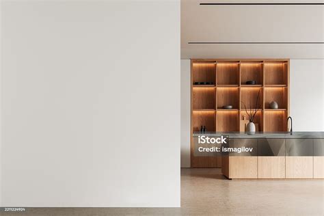 나무 캐비닛이 있는 미니멀한 주방 인테리어와 포스터 또는 삽화 모형 프레젠테이션 템플릿 레이아웃 디자인을 위한 왼쪽에 큰 빈 벽이 있습니다 3d 렌더링 0명에 대한 스톡