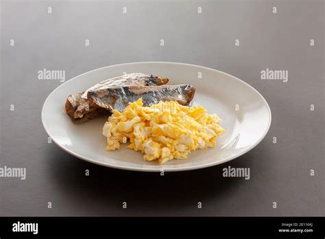 Kippers With Scrambled Eggs Served On A White Plate A Kipper Is A