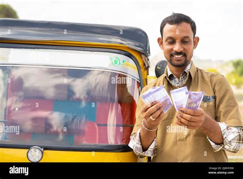 Happy Smiling Auto Rickshaw Driver Counting Money While Standing Next