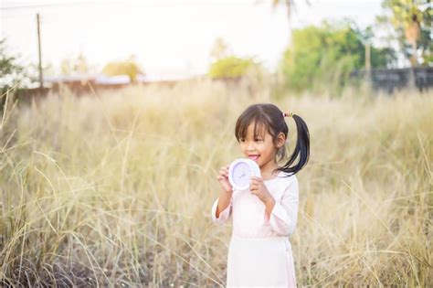 Premium Photo Portrait Of A Girl Standing On Field