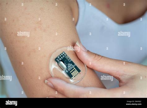 Person Applying Health Monitoring Sensor To Arm Stock Photo Alamy