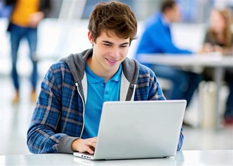A College Student Intently Coding On His Laptop Making Final Project