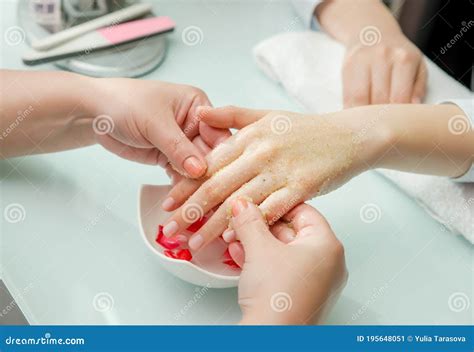 Woman Hands In A Nail Salon Receiving A Hand Massage By A Beautician