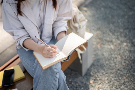 Premium Photo A Female Is Keeping Her Diary Or Taking Notes In Her