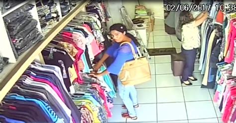 Câmera de segurança flagra mulher furtando roupa em loja no centro de