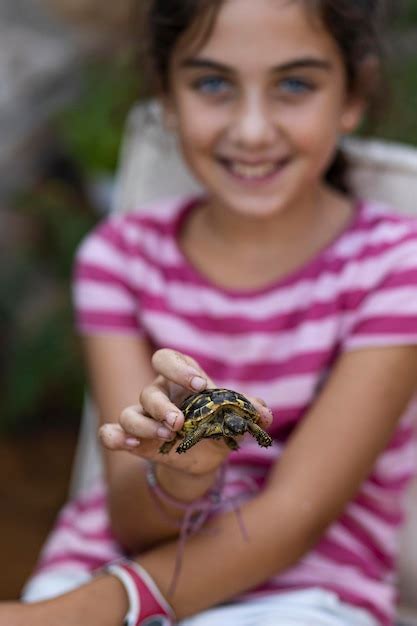 Premium Photo Portrait Of Smiling Girl With A Turtle