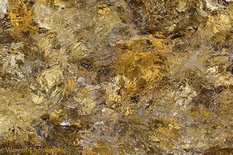 A Clear Stream Flowing Over Colourful Pebbles Photo WP38554