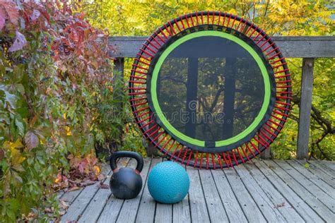 Mini Trampoline For Fitness Exercising And Rebounding Slam Ball And Iron Kettlebell Stock Image