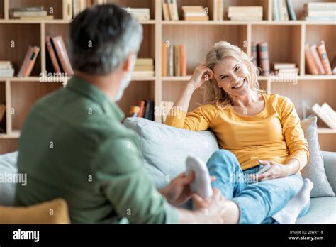 Caring Man Massaging Feet Of His Wife While They Relaxing On Couch Stock Photo Alamy