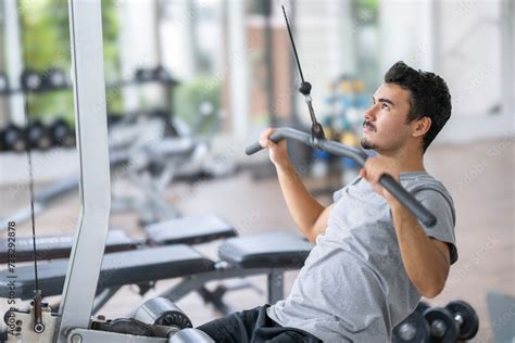 Dynamic Image Of A Man Pushing His Limits With A Cable Chest Workout