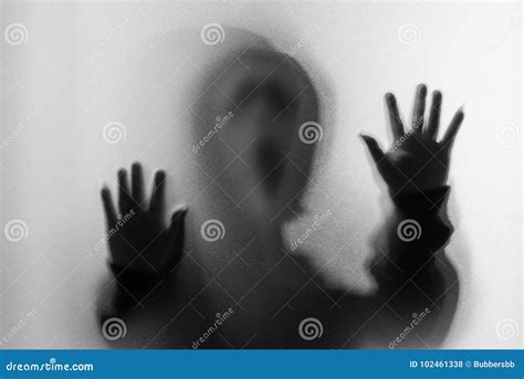 Shadow Blur Of Horror Man In Screaming Mask And Hand Touches The Stock