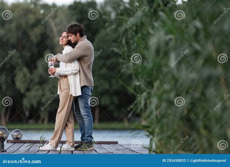 Young Man Hugging Girlfriend With Glass Stock Image Image Of Plants
