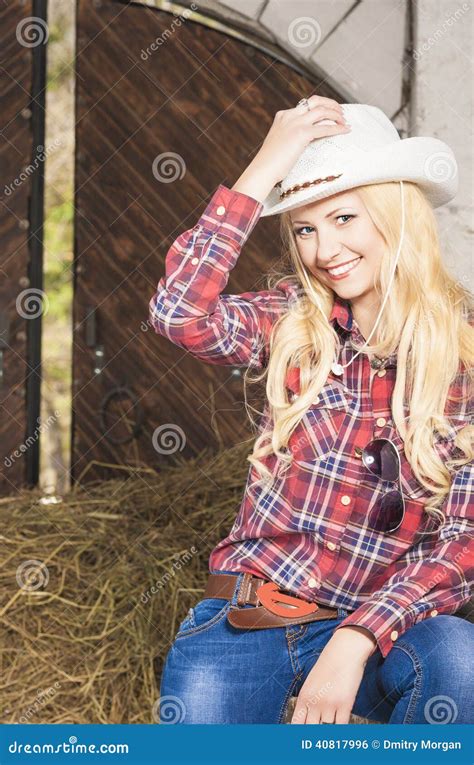 Sensual Blond Cowgirl Smiling Inside Of The Farm House Vertical Stock