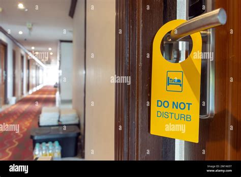 The Sign Do Not Disturb Hangs On The Doorknob Of The Open Hotel Room