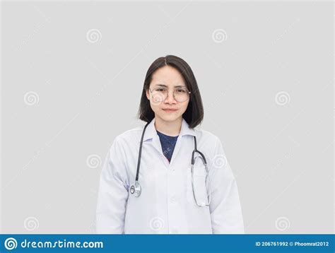 Portrait Female Doctor Standing On White Background In Uniform Wear
