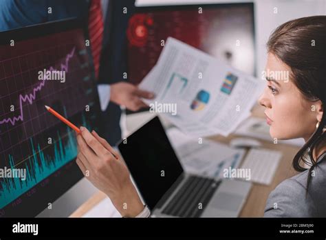 Selective Focus Of Information Security Analyst Pointing On Charts On