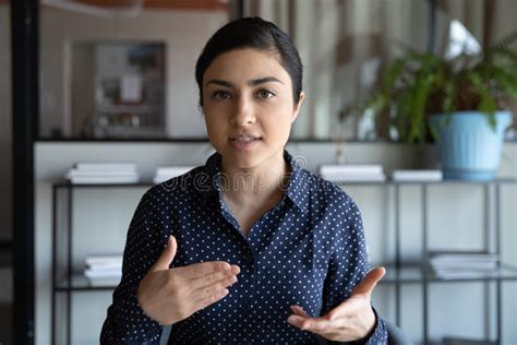 Focused Young Indian Woman Holding Negotiations Video Call With Clients