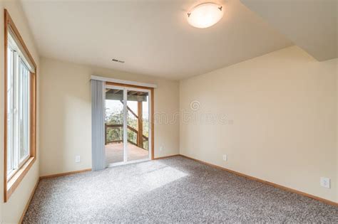 Empty Room With Gray Carpet White Walls Wood Trim Sliding Glass Door To